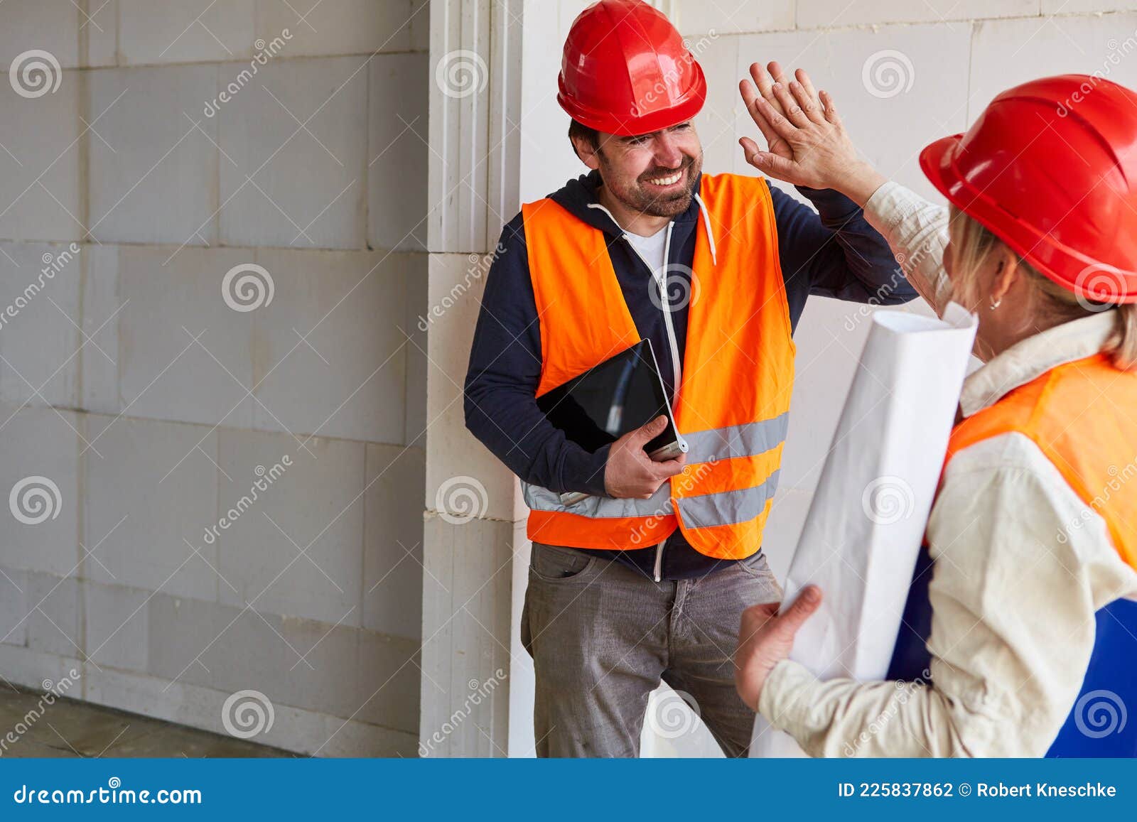 Construction Worker and Architect Giving the High Five on a ...
