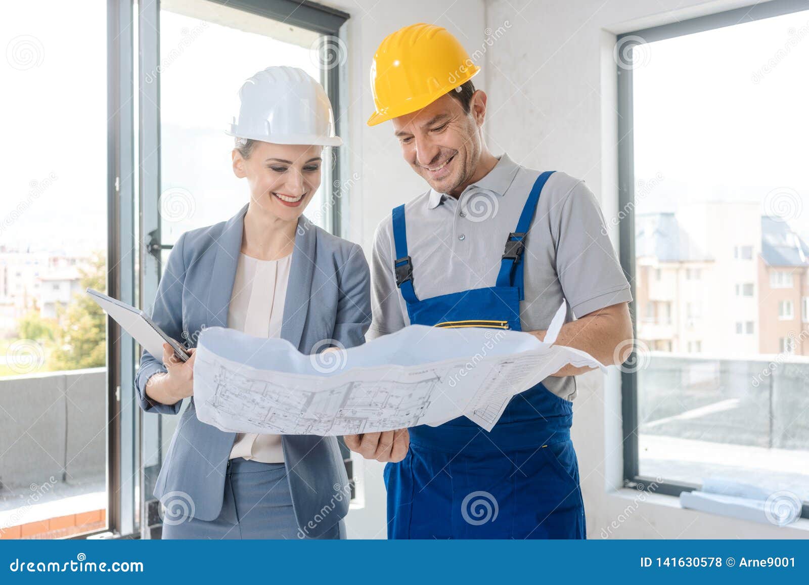 Construction Worker and Architect Looking at Plan on Site Stock Photo ...