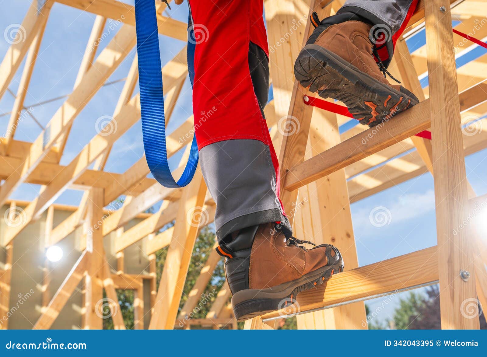 Construction Worker Climbing a Ladder while Wearing Safety Gear at a ...