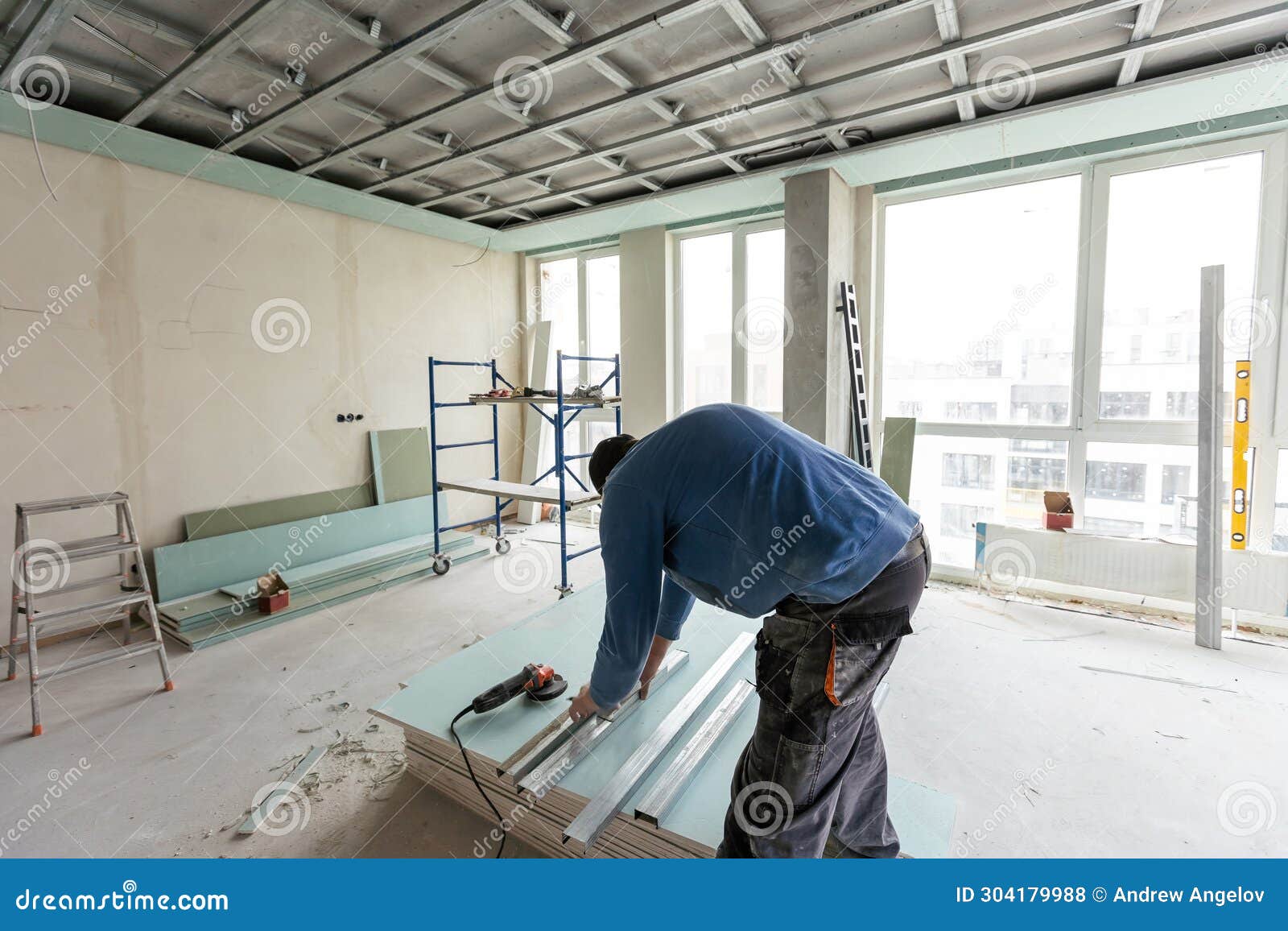 Construction Worker Assemble a Suspended Ceiling with Drywall and ...