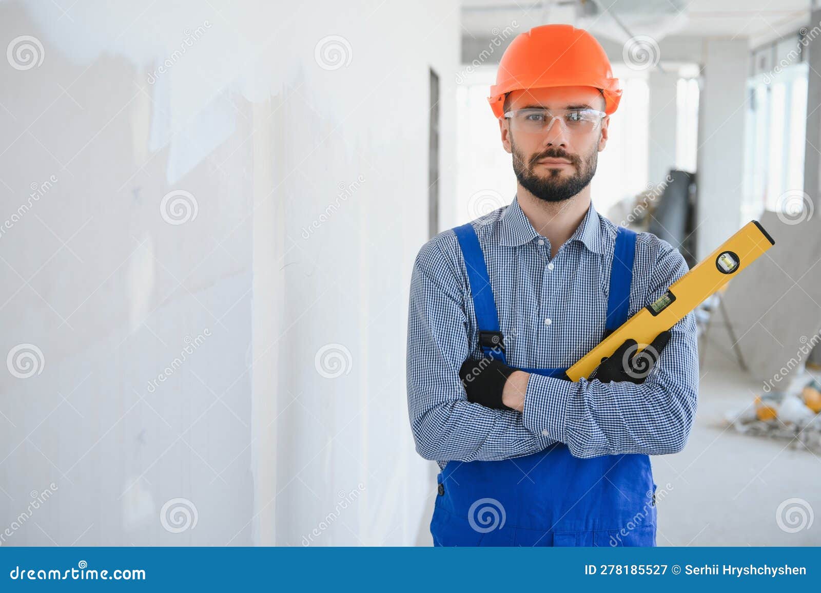 Construction Worker in Blue Uniform with Spirit Level Stock Image ...