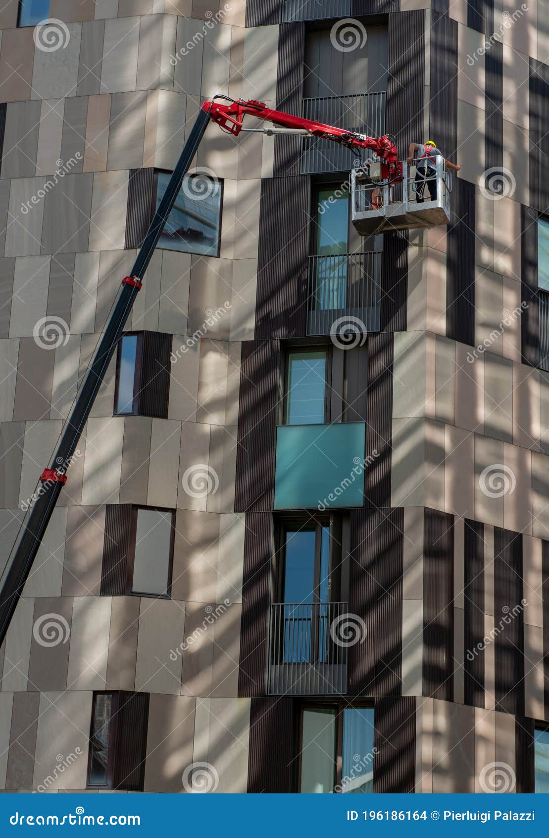 Construction Worker on a Boom Lift on the Side of a Building Stock ...