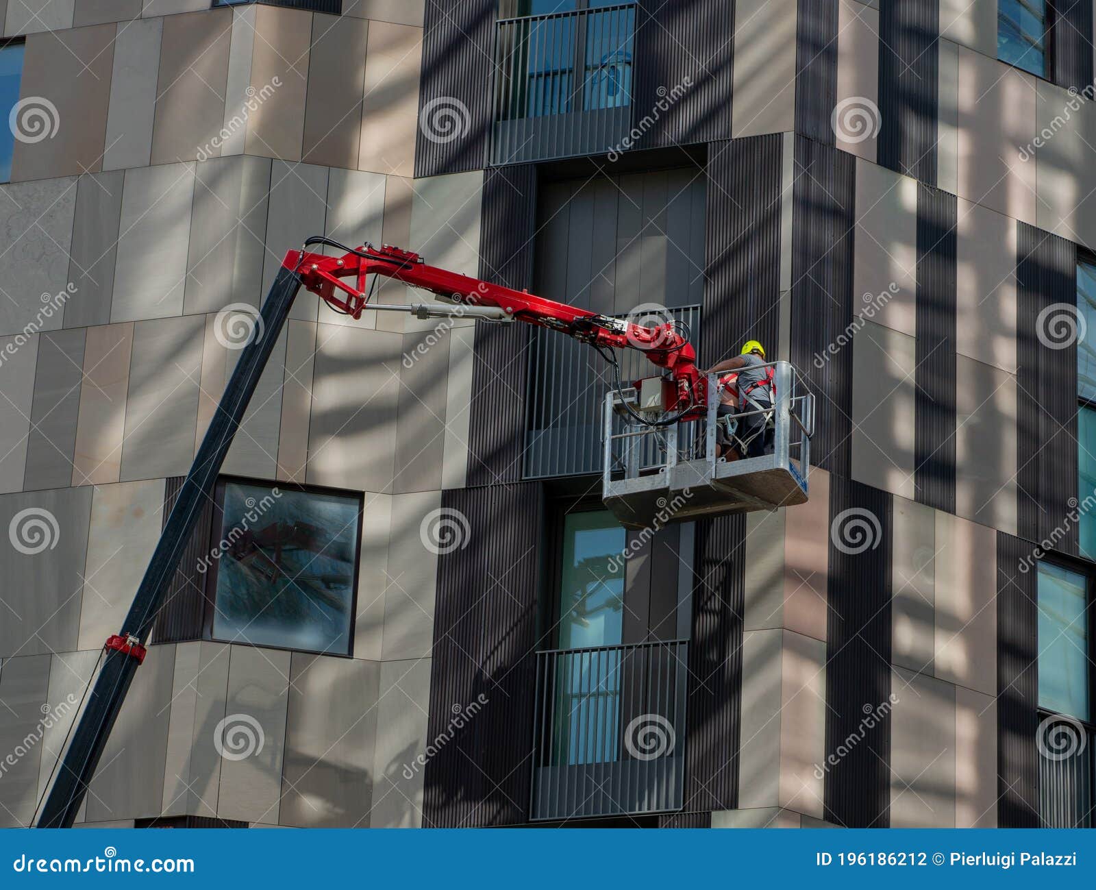 Construction Worker on a Boom Lift on the Side of a Building Stock ...