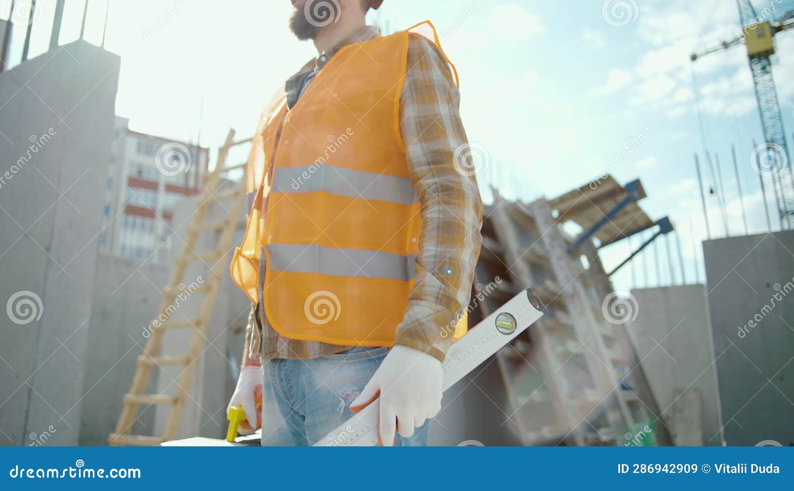 Construction Worker with Bubble Level Meter and Toolbox Standing on ...