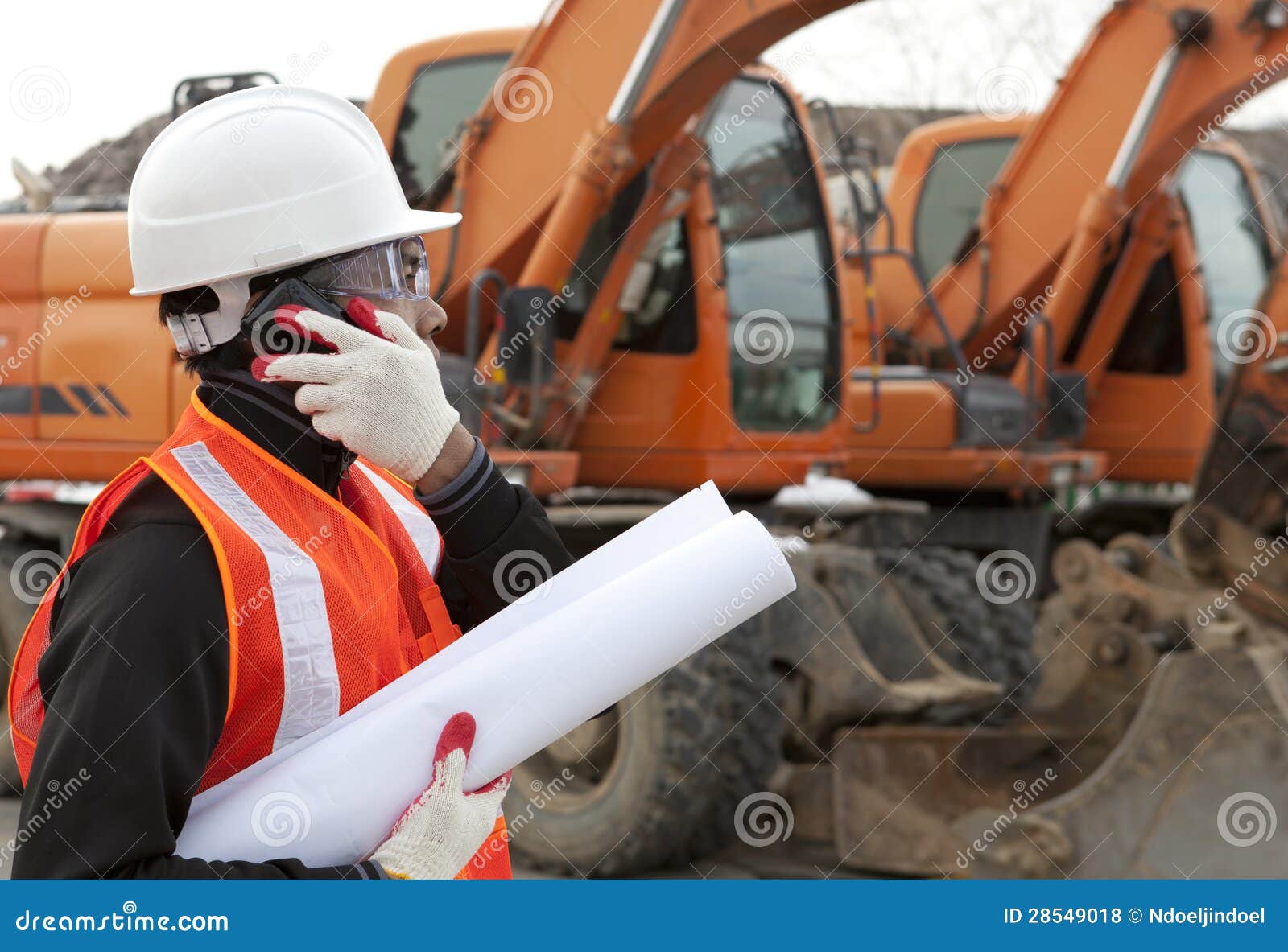 Construction Worker with Building Plans and Cellphone Stock Photo ...