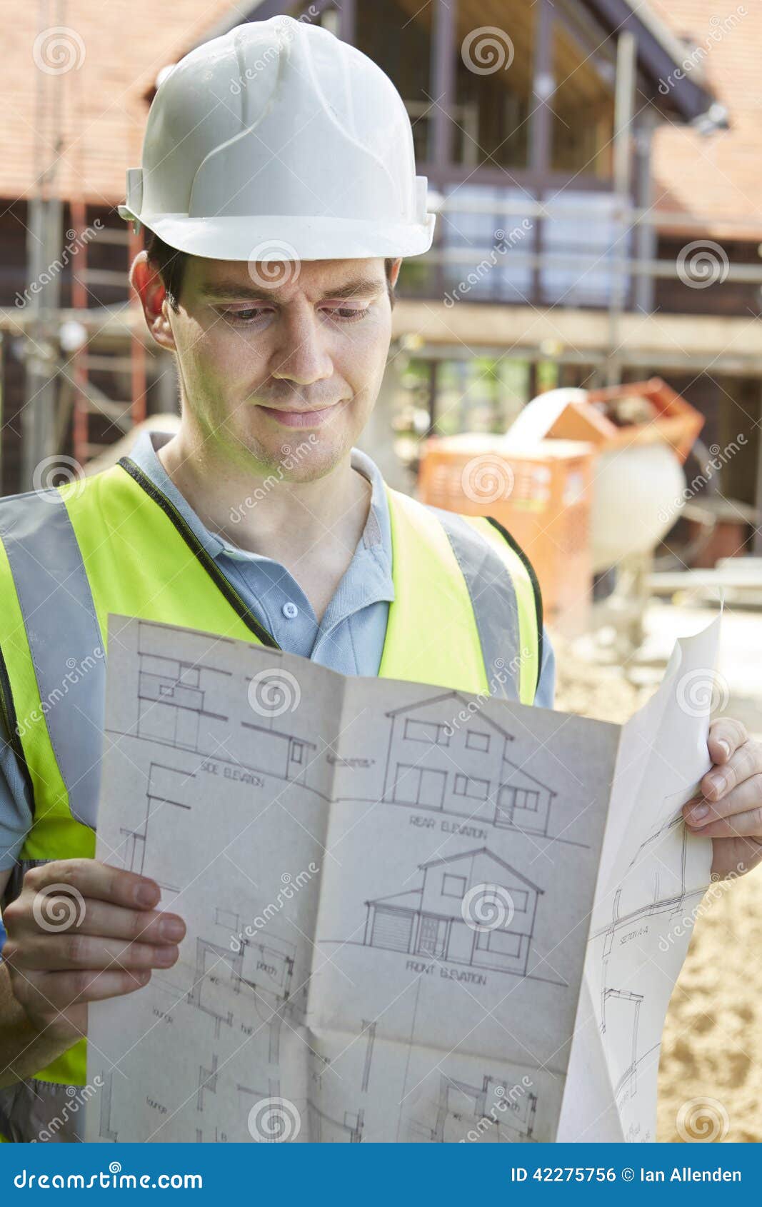 Construction Worker on Building Site Looking at House Plans Stock Photo ...