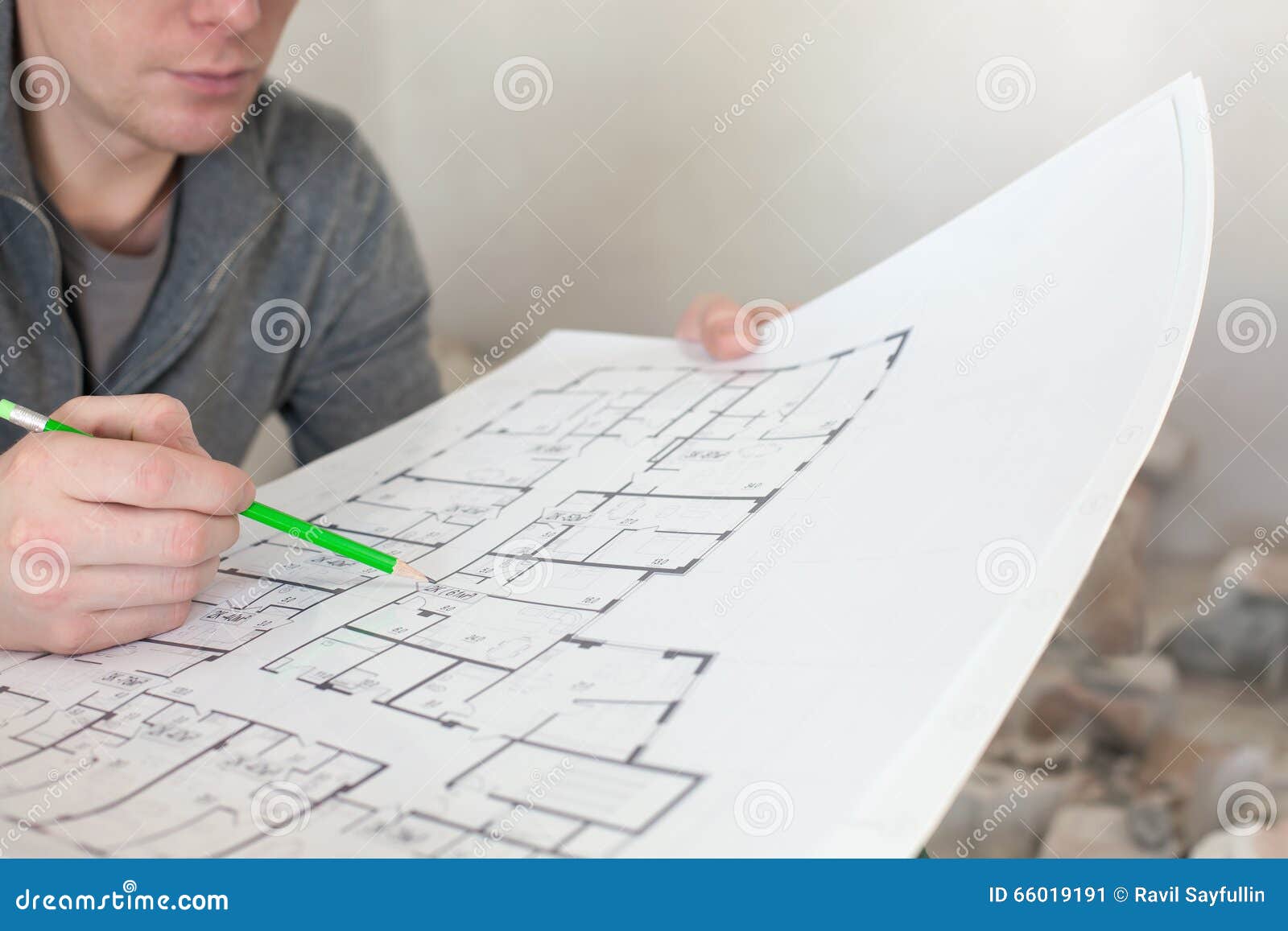 A Construction Worker Checking Documents with Pencil in His Hand Stock ...