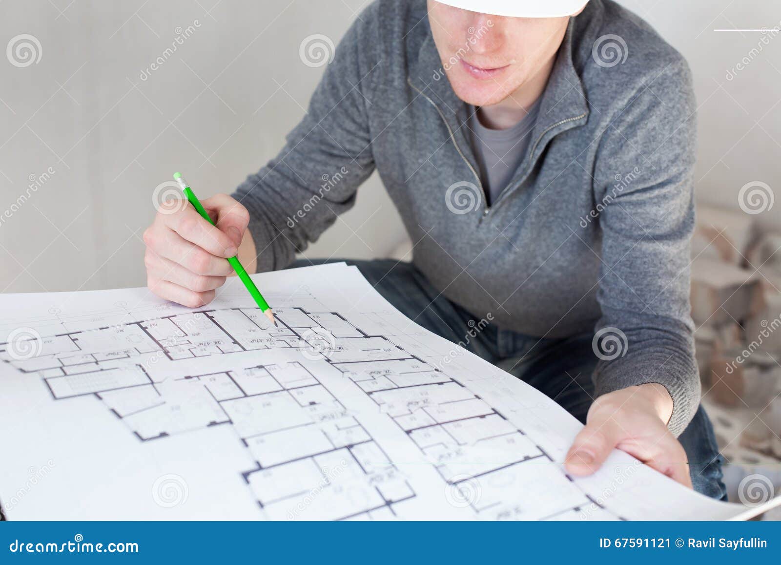 A Construction Worker Checking Documents with Pencil in His Hand Stock ...