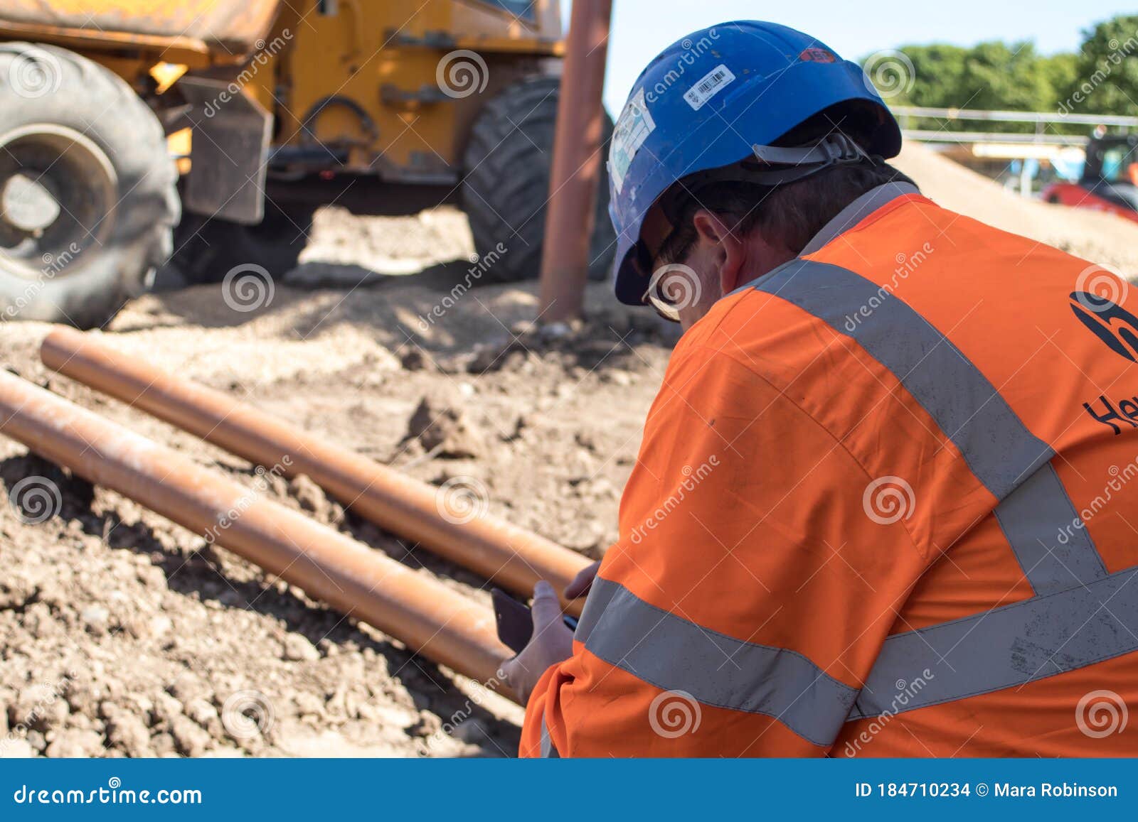 Construction Worker Checking His Mobile Phone on a Building Site ...