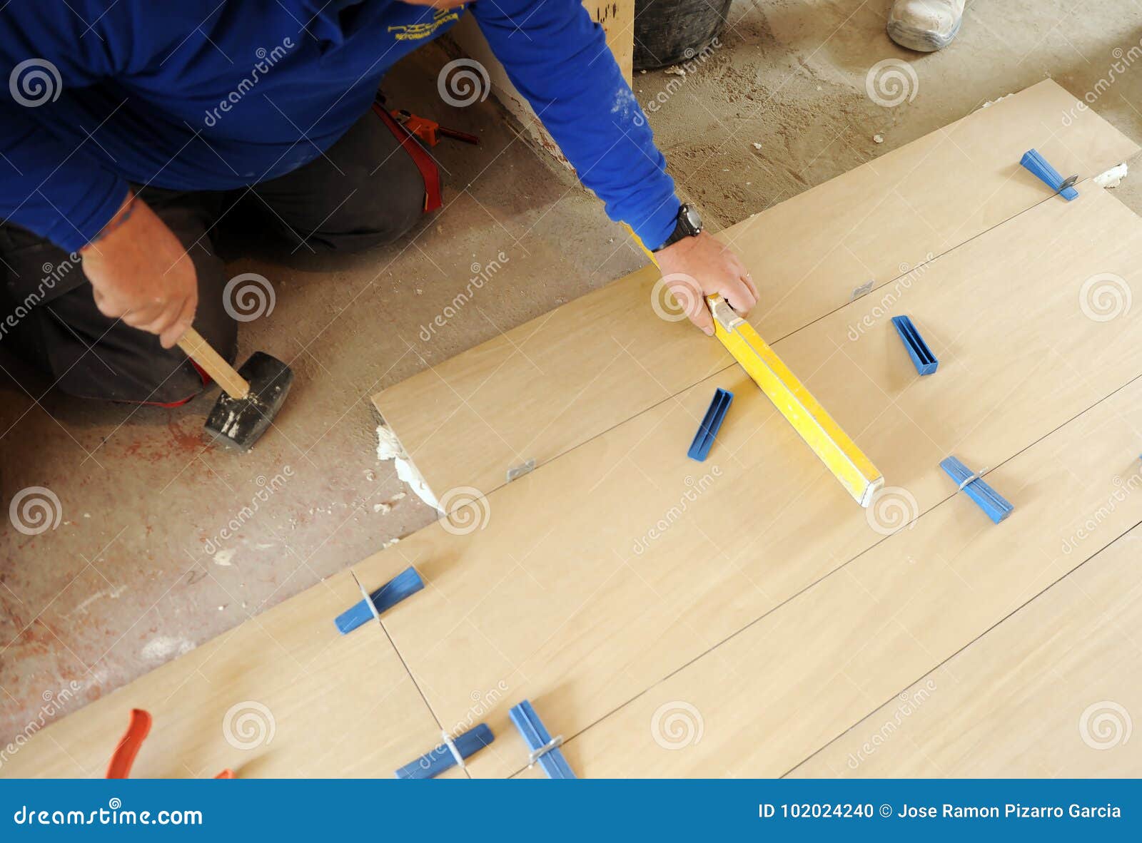 Construction Worker Checking with the Level Tool the Correct Placement ...