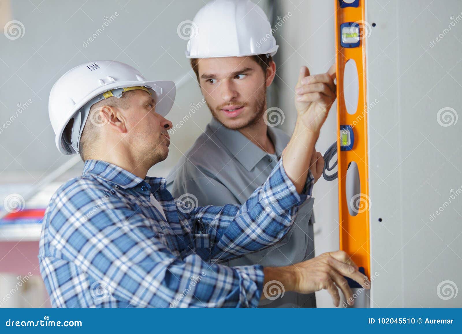 Construction Worker Checks Level on Wall Stock Photo - Image of ...