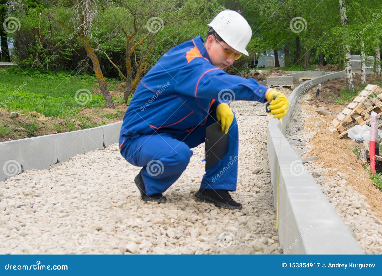 Construction Worker Checks the Progress of Laying Curbstone and Rubble ...
