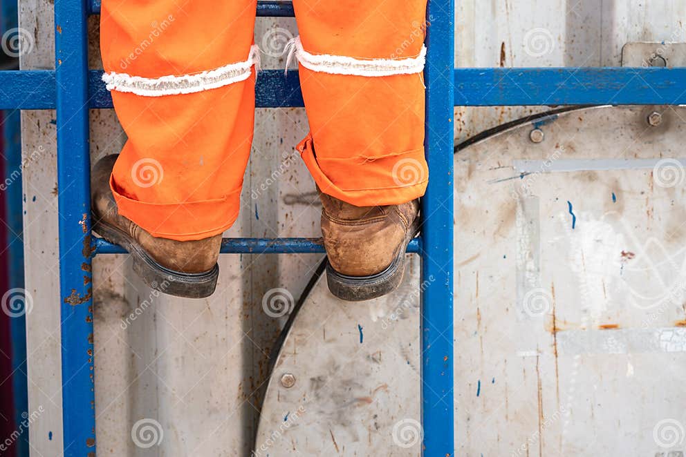 A Construction Worker is Climbing on the Platform Ladder. Stock Photo ...