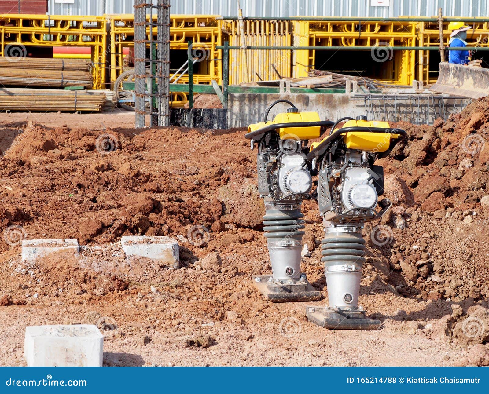 Worker Compacting Soil With Vibration Compaction Machine During ...
