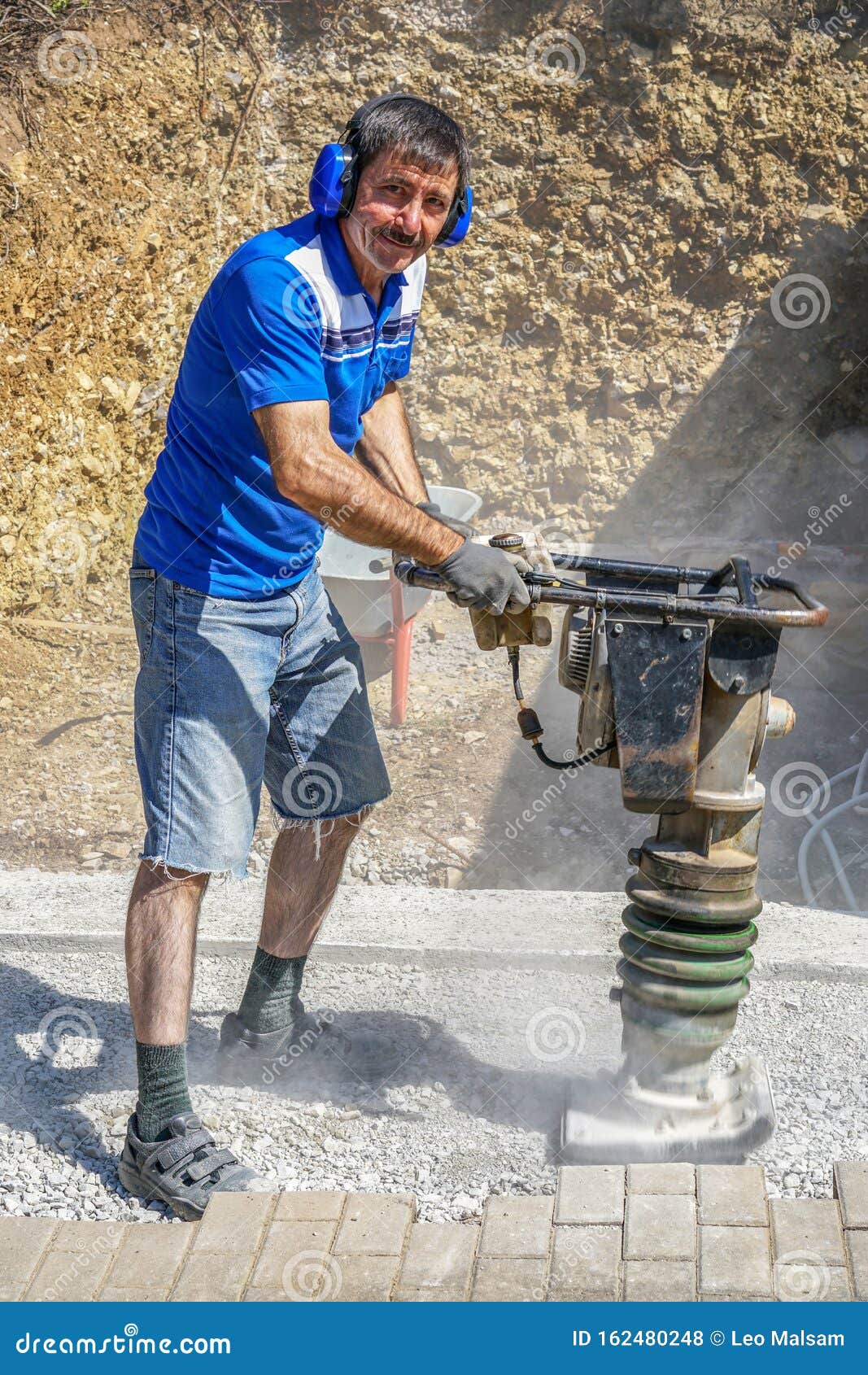 Construction Worker Compacting Soil Using Compactor. Stock Photo ...