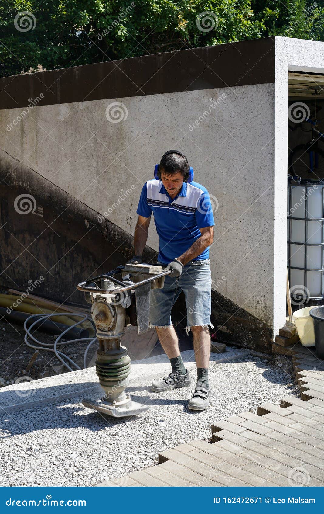 Construction Worker Compacting Soil Using Compactor. Stock Image ...