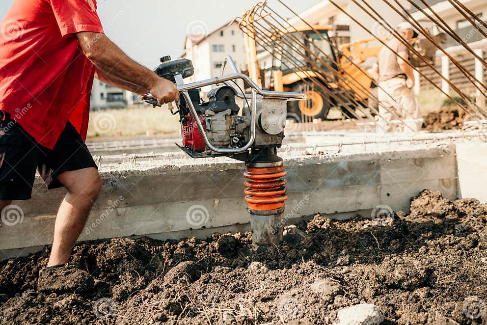 Construction Worker Compacting Soil with Vibration Compaction Machine ...