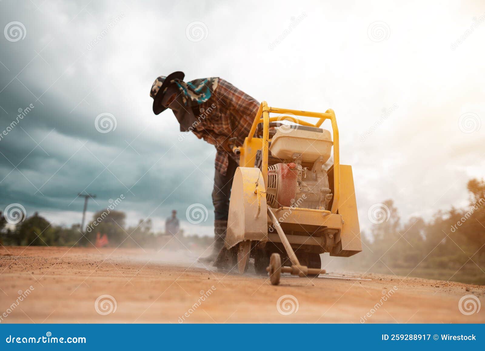 Construction Worker Concrete Cutting in the Road Construction Stock ...