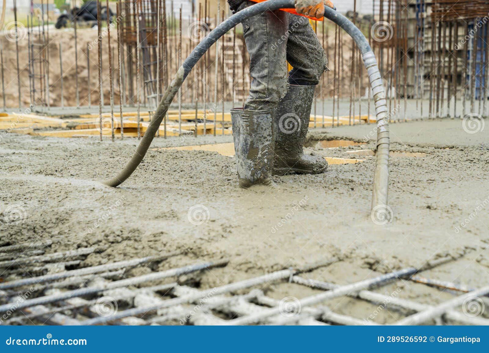 Construction Worker Pouring Concrete During Commercial Concreting