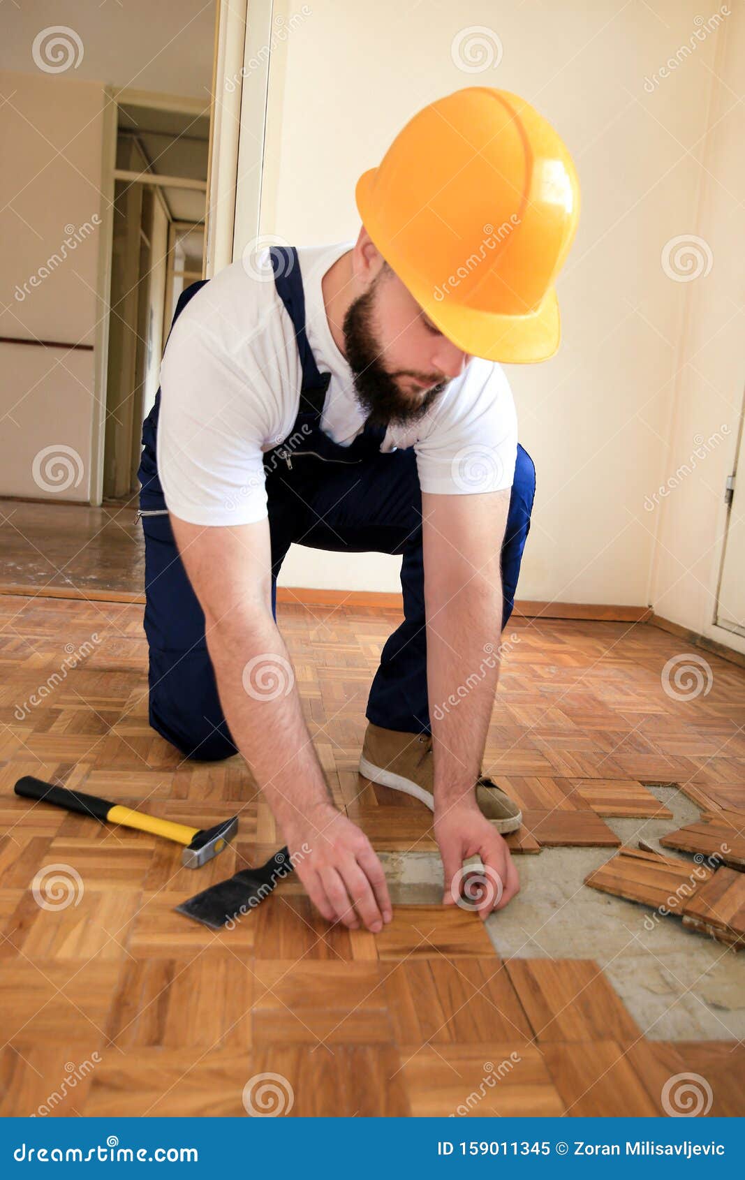 Construction Worker and Handyman is Removing Old Wooden Parquet ...