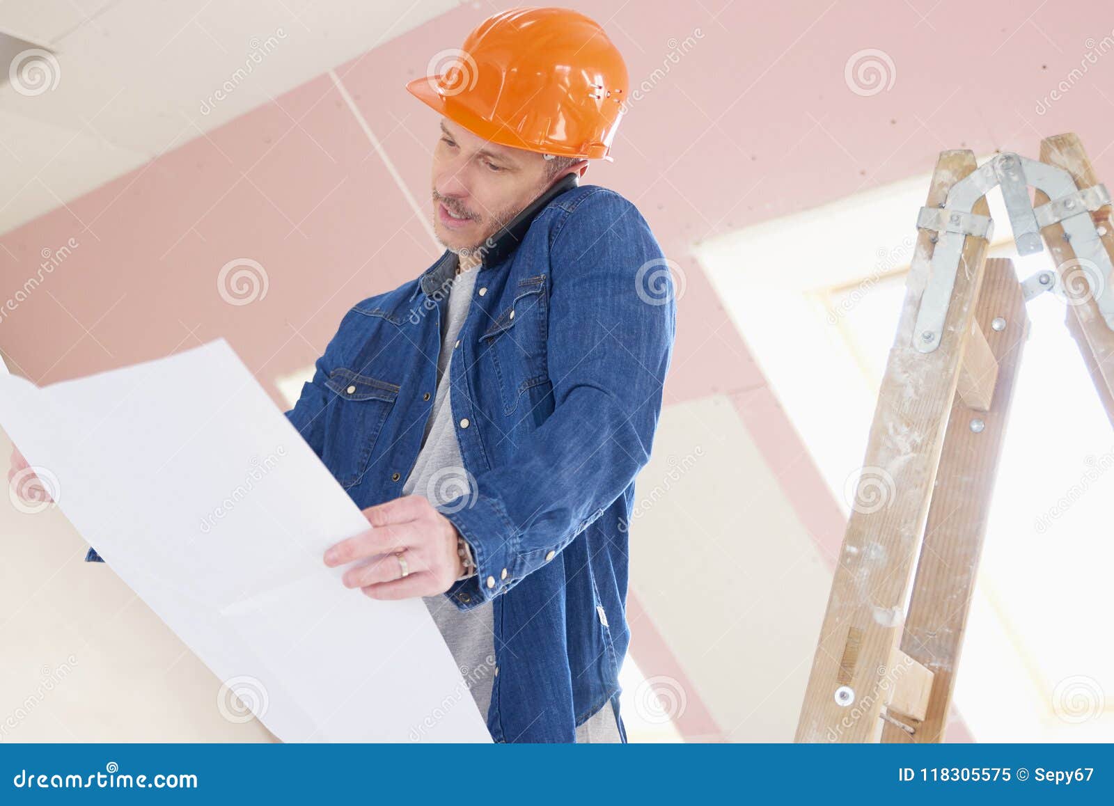 Construction Worker Consulting on His Mobile Phone Stock Image - Image ...
