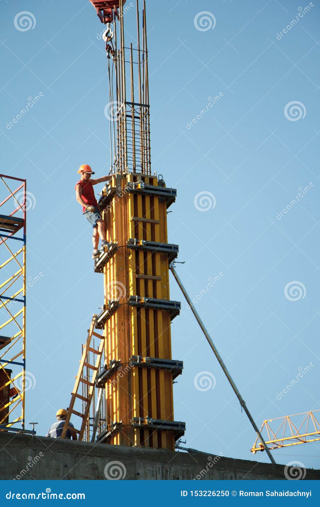 A Construction Worker Controls the Crane Movement when Assembling ...