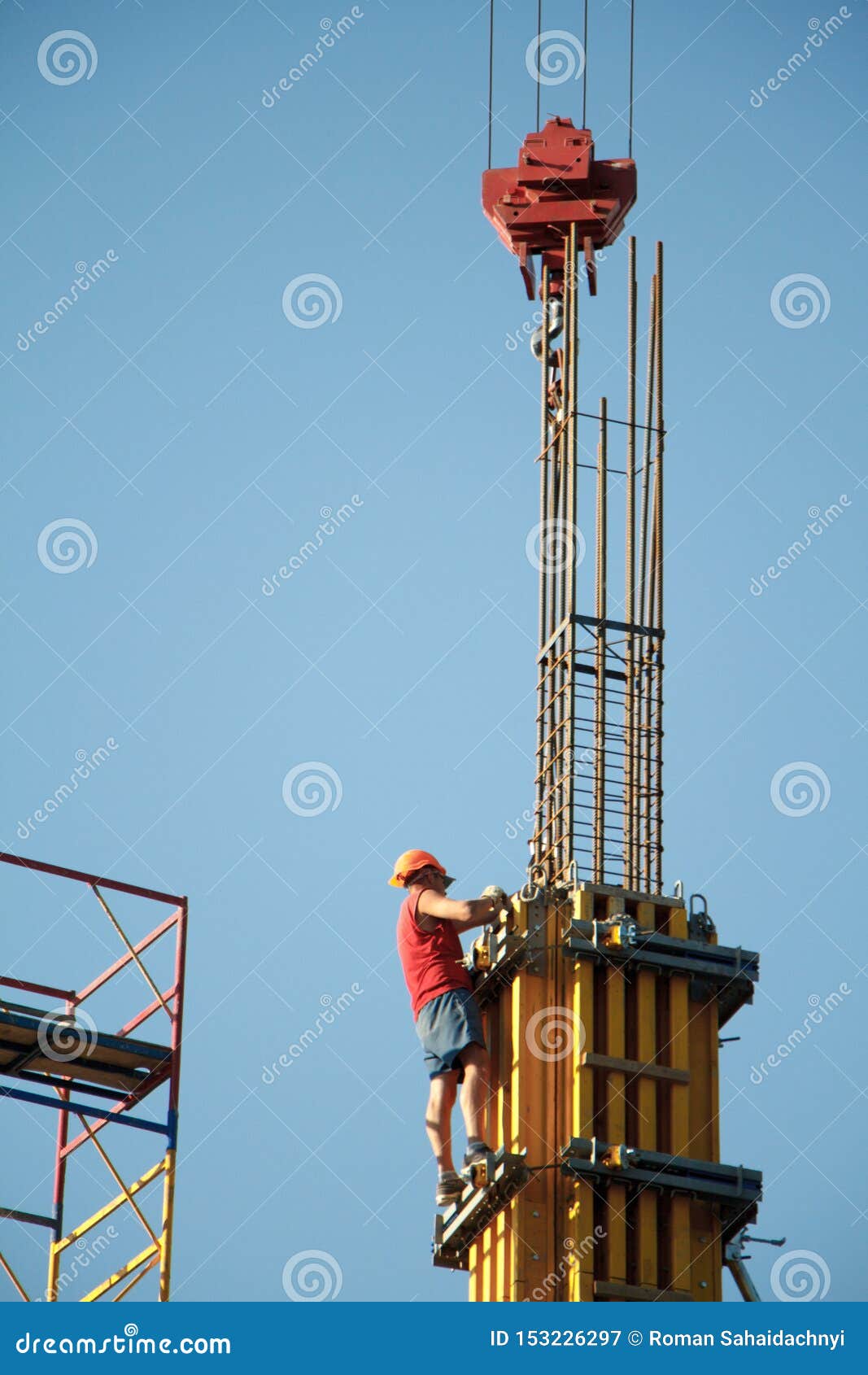 A Construction Worker Controls the Crane Movement when Assembling ...