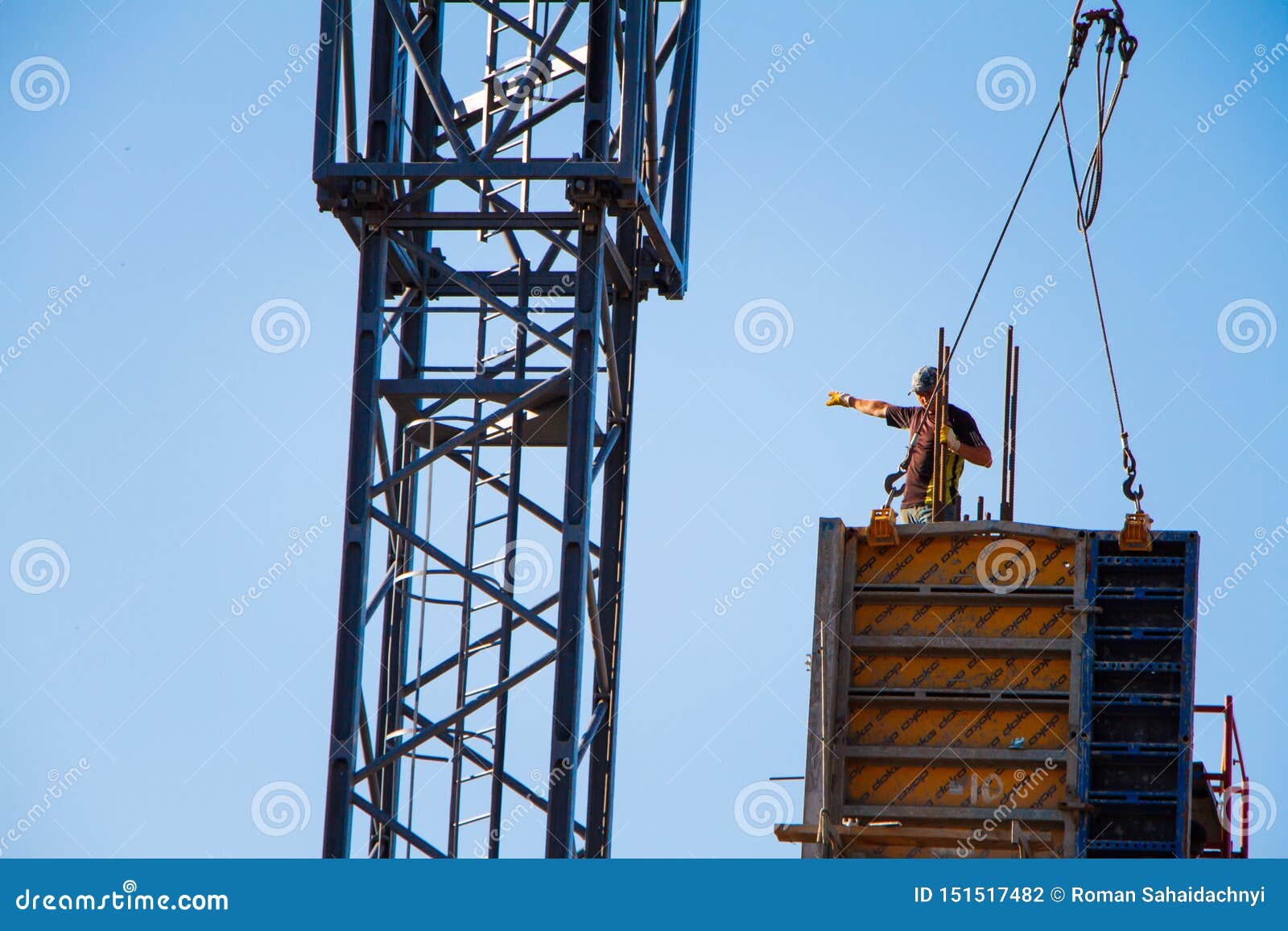 A Construction Worker Controls the Crane Movement when Assembling ...