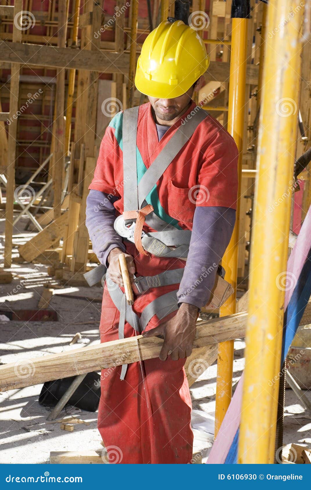 Construction Worker Cuts Board - Vertical Stock Photo - Image of team ...