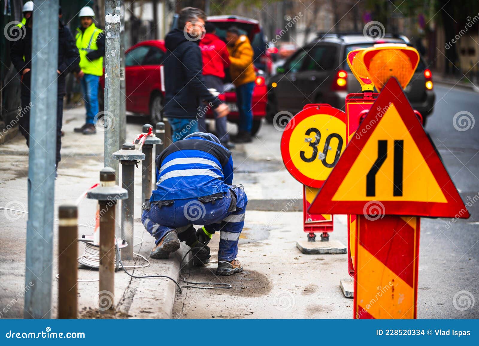 Construction Worker Cutting Asphalt Paving Stabs for Sidewalk Using a ...