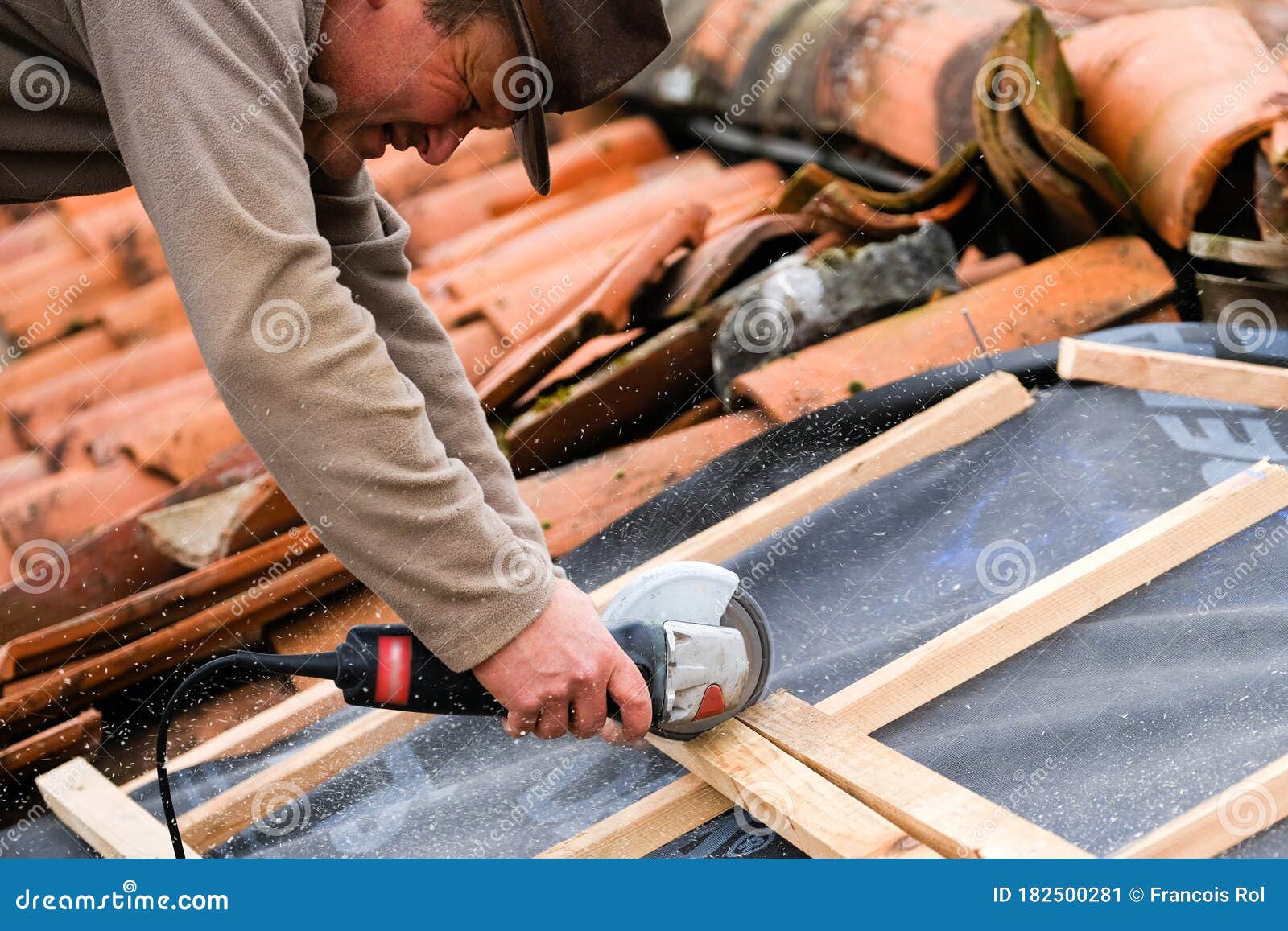 Construction Worker Cutting with a Disc-maker a Wood Cleat for the ...
