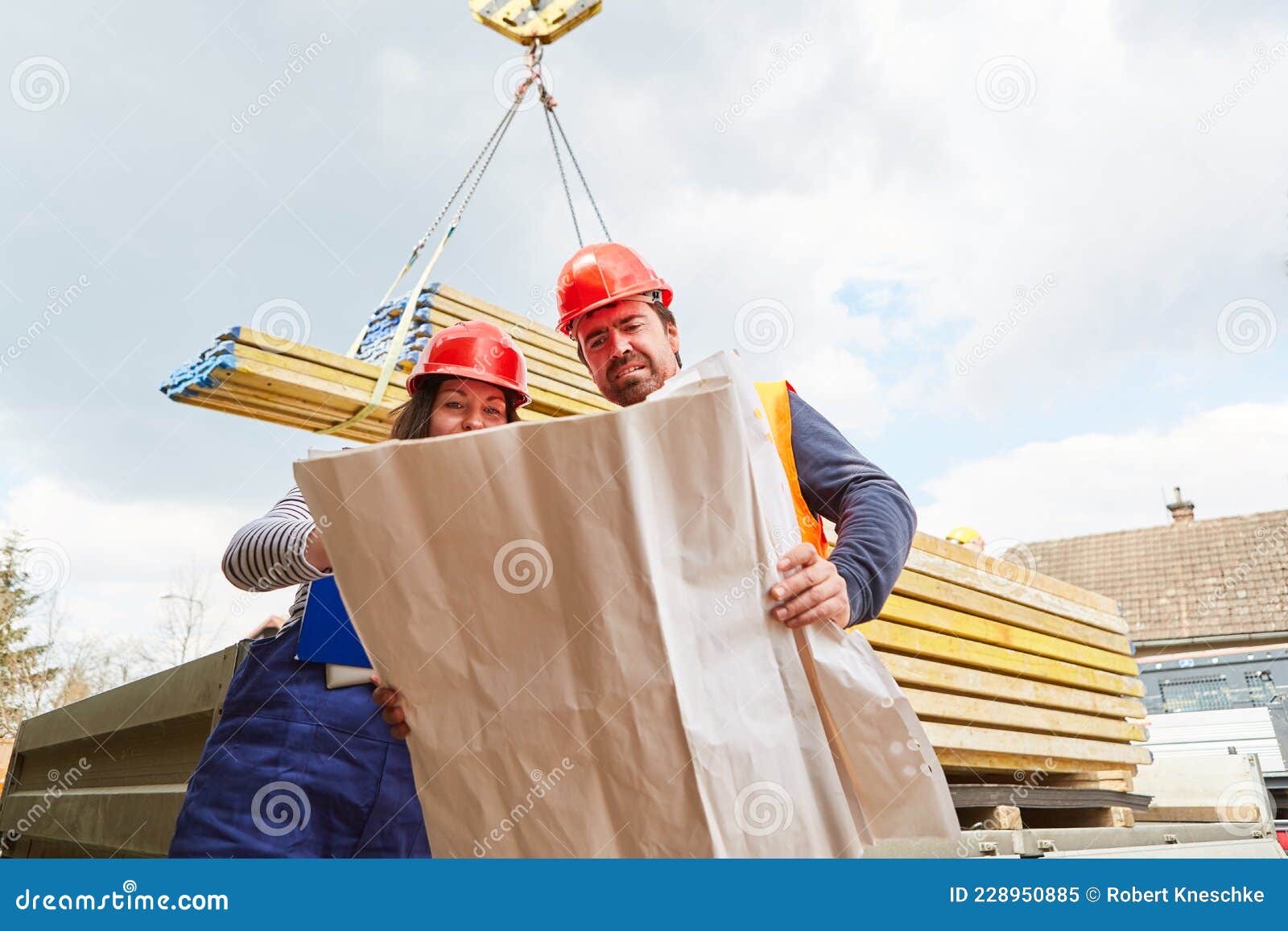 Construction Worker with Delivery of Building Materials in the ...