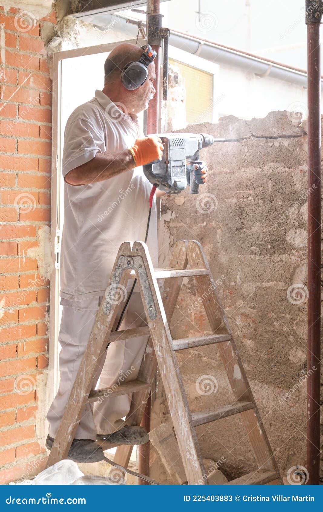 Builder with Demolition Hammer Breaking a House Wall. Stock Image ...