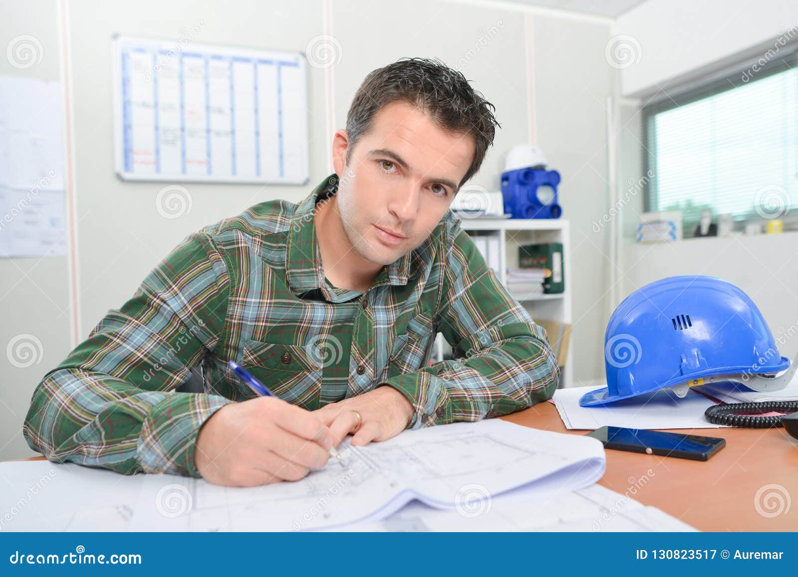 Construction Worker at Desk Stock Image - Image of serious, investigate ...