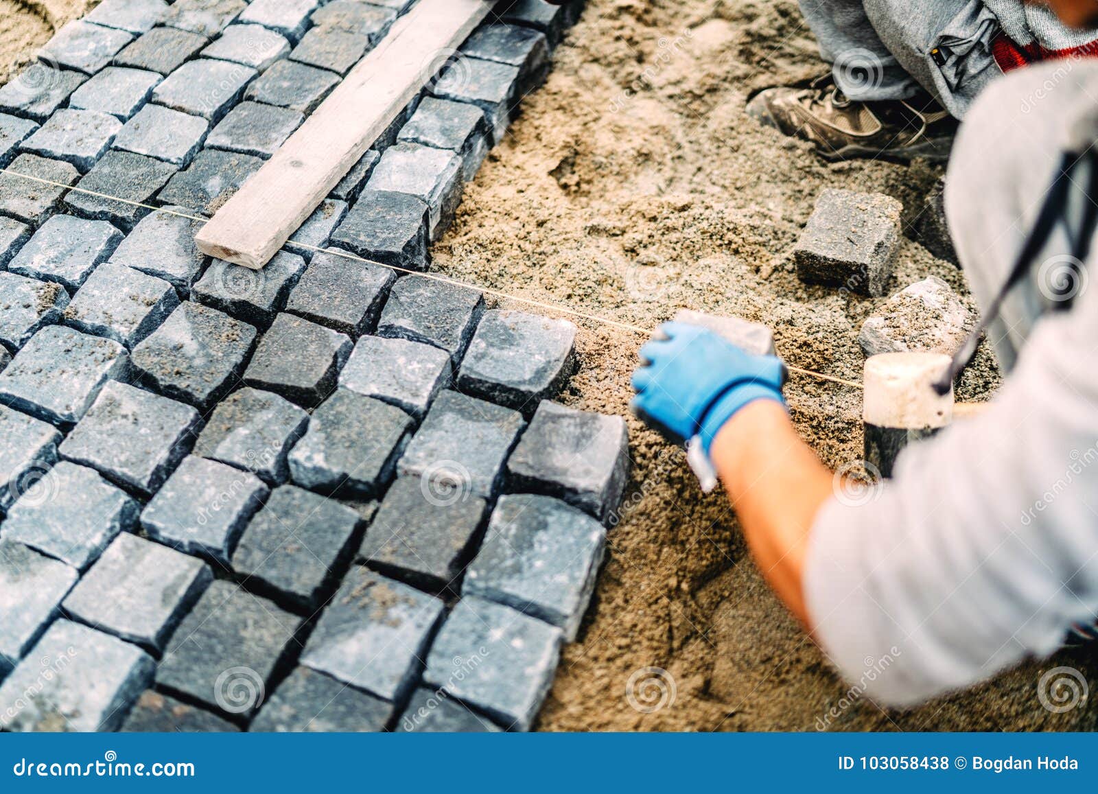 Construction Worker.Building of Road or Sidewalk with Granite Stone As ...