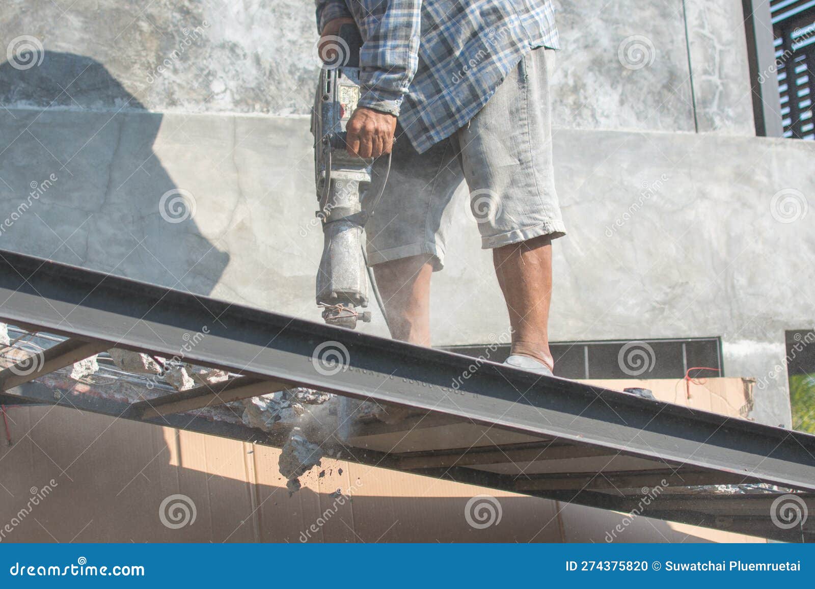 The Construction Worker is Drilling the Floor. Construction Technicians ...