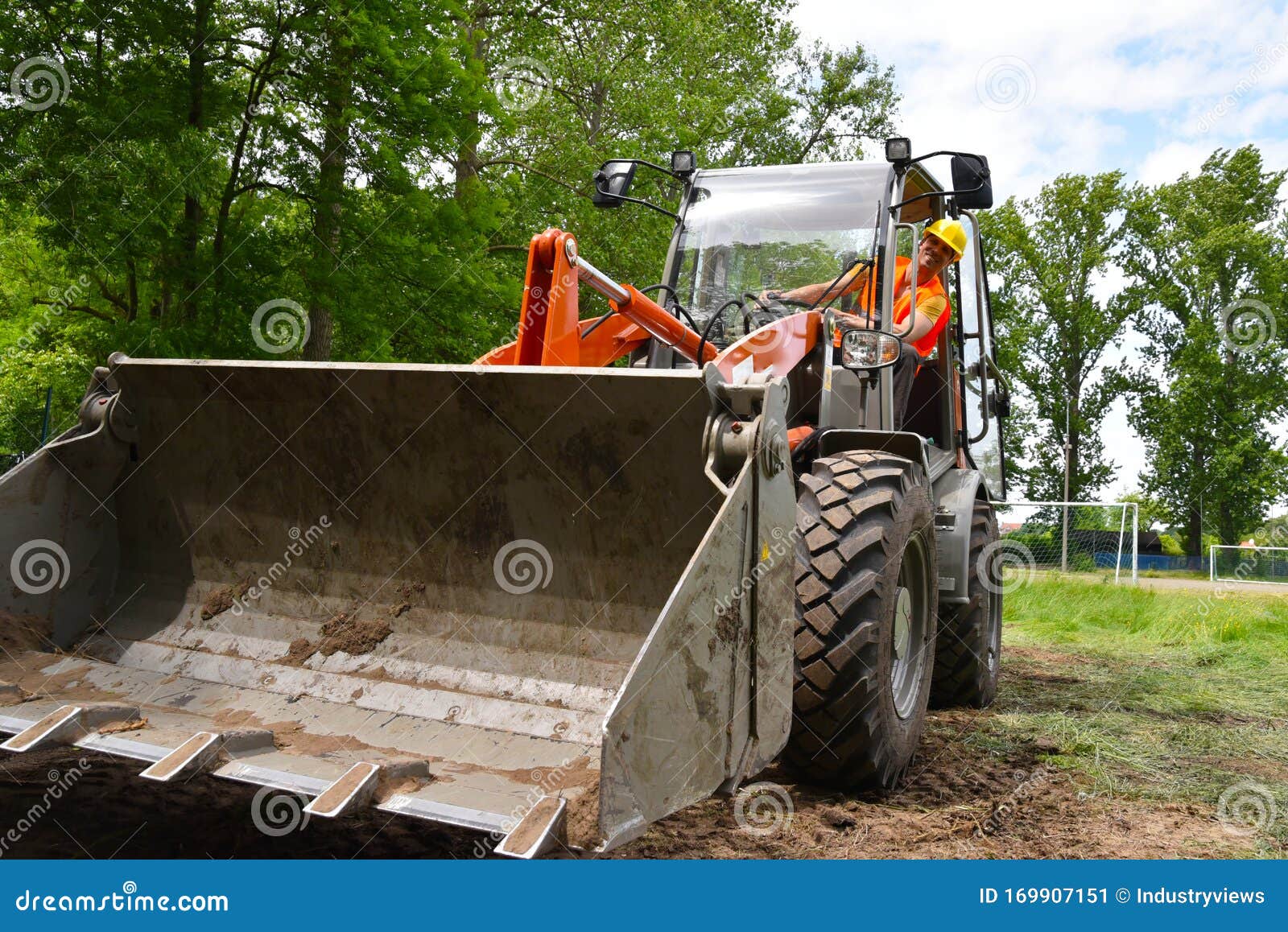 Construction Worker Drives a Small Wheel Loader on the Construction ...