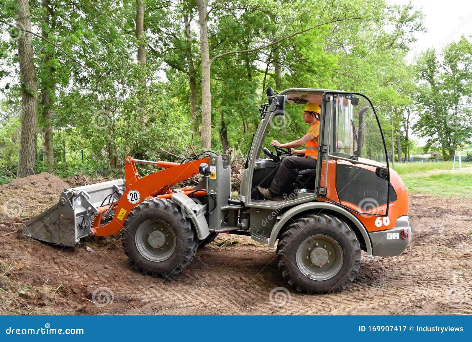 Construction Worker Drives a Small Wheel Loader on the Construction ...