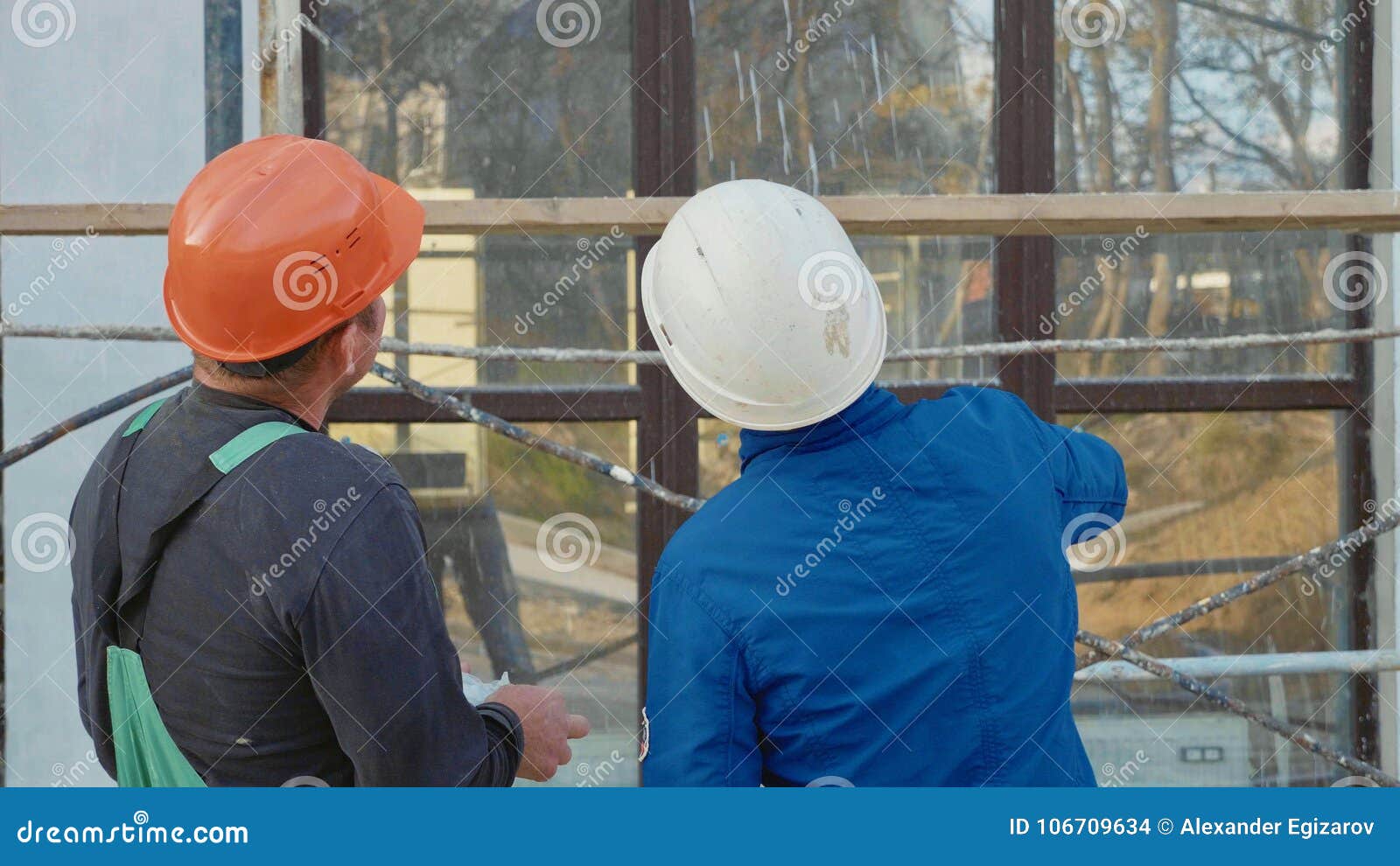 Construction Worker and Engineer Talking at Construction Site Site ...