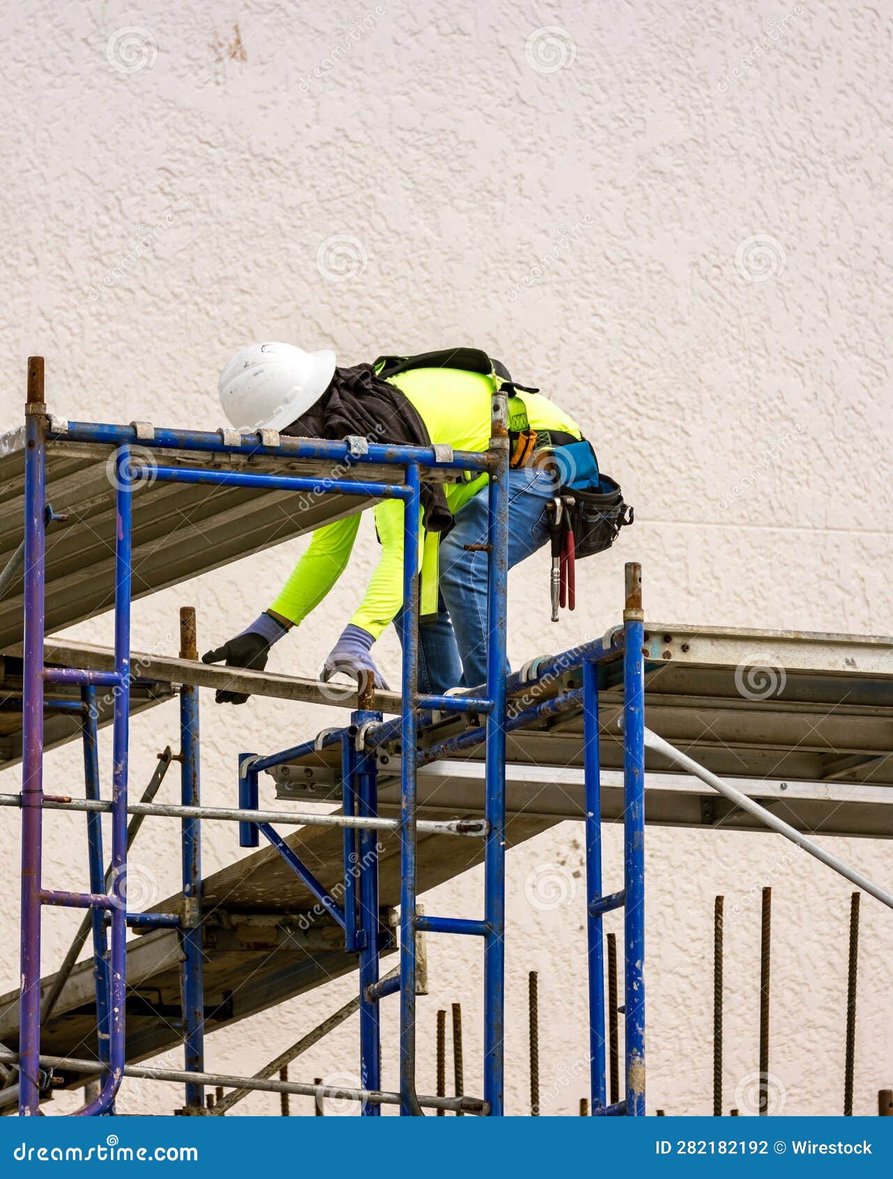 Construction Worker with Face Mask Installing Scaffolding for Building ...