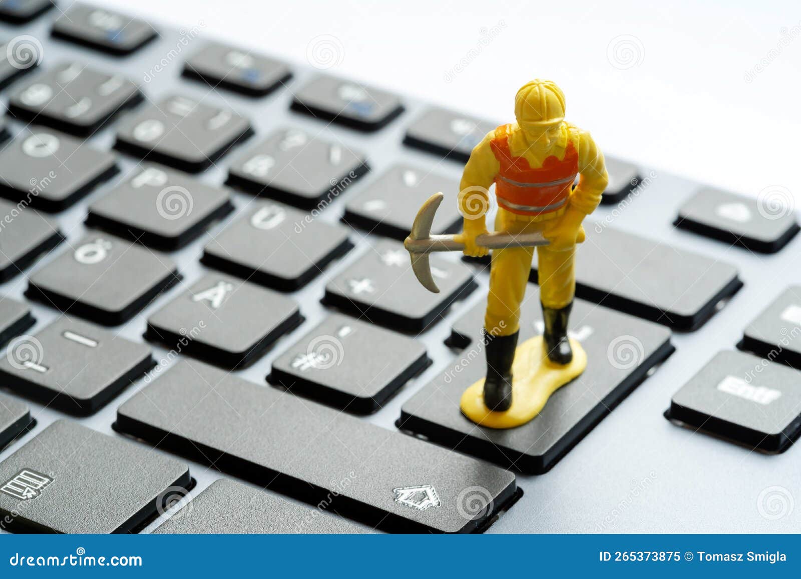 Construction Worker Figurine with a Pickaxe Standing on Top of a Simple ...