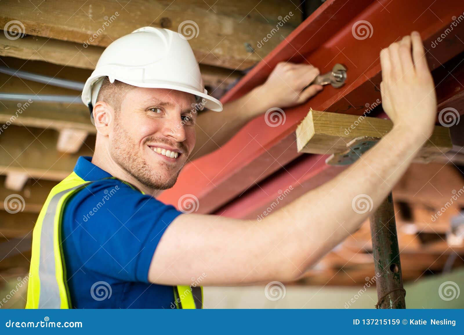 Construction Worker Fitting Steel Support Beam into Renovated House ...
