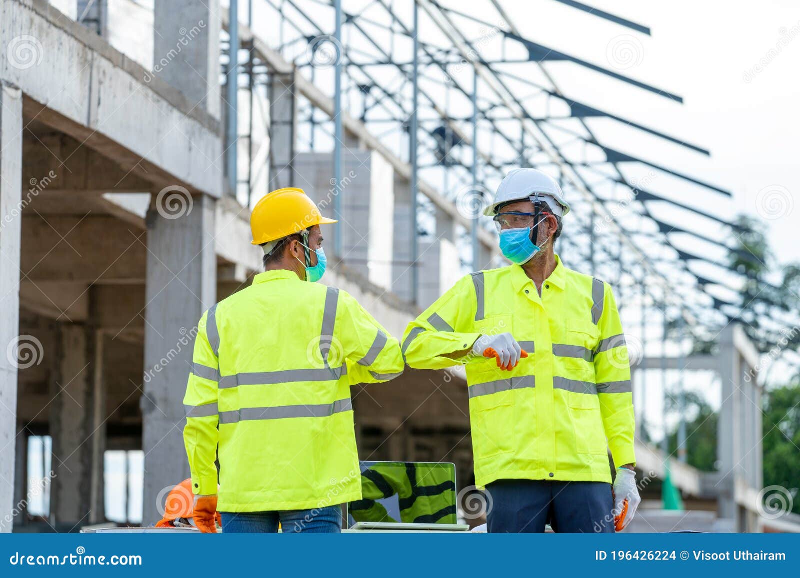 Construction Worker Greeting with Elbows while Wearing Protective Face ...