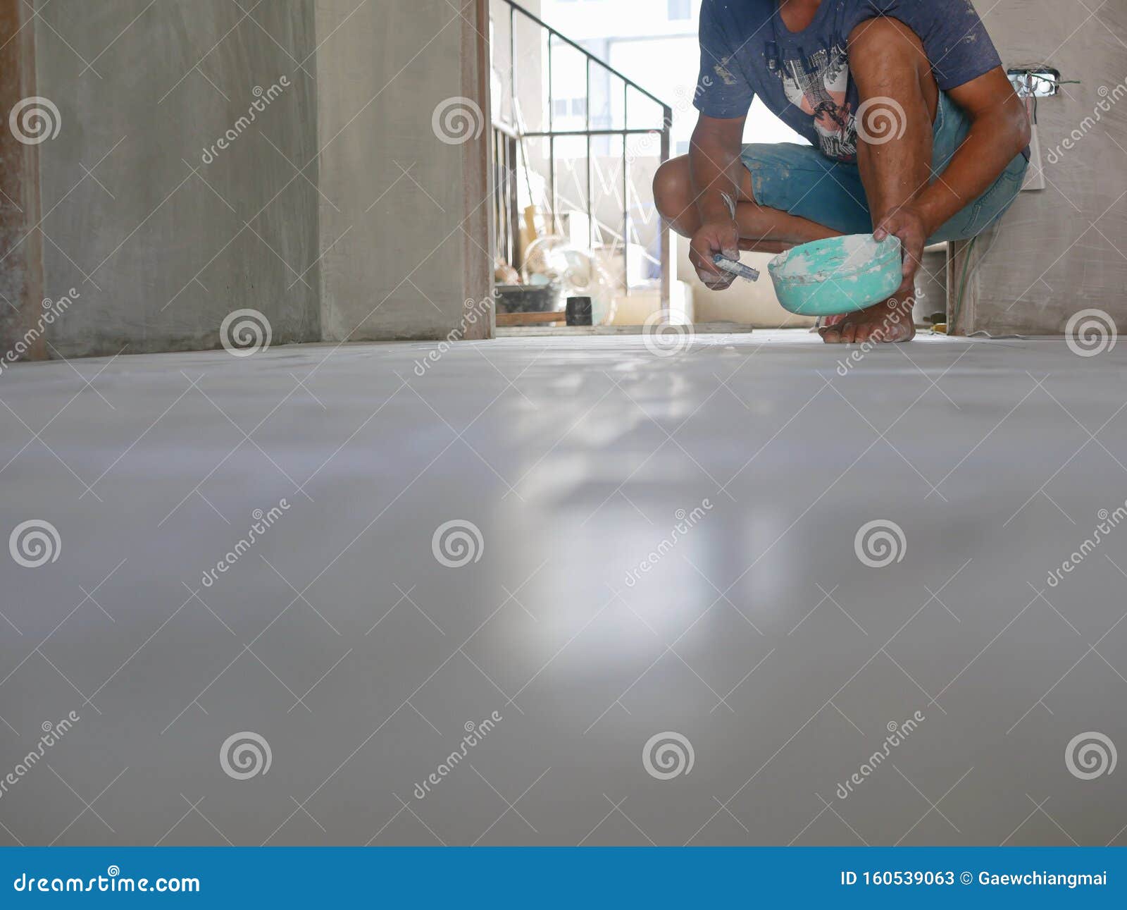 A Construction Worker Grunting the Ceramic Tile Floor - Tiling Work ...