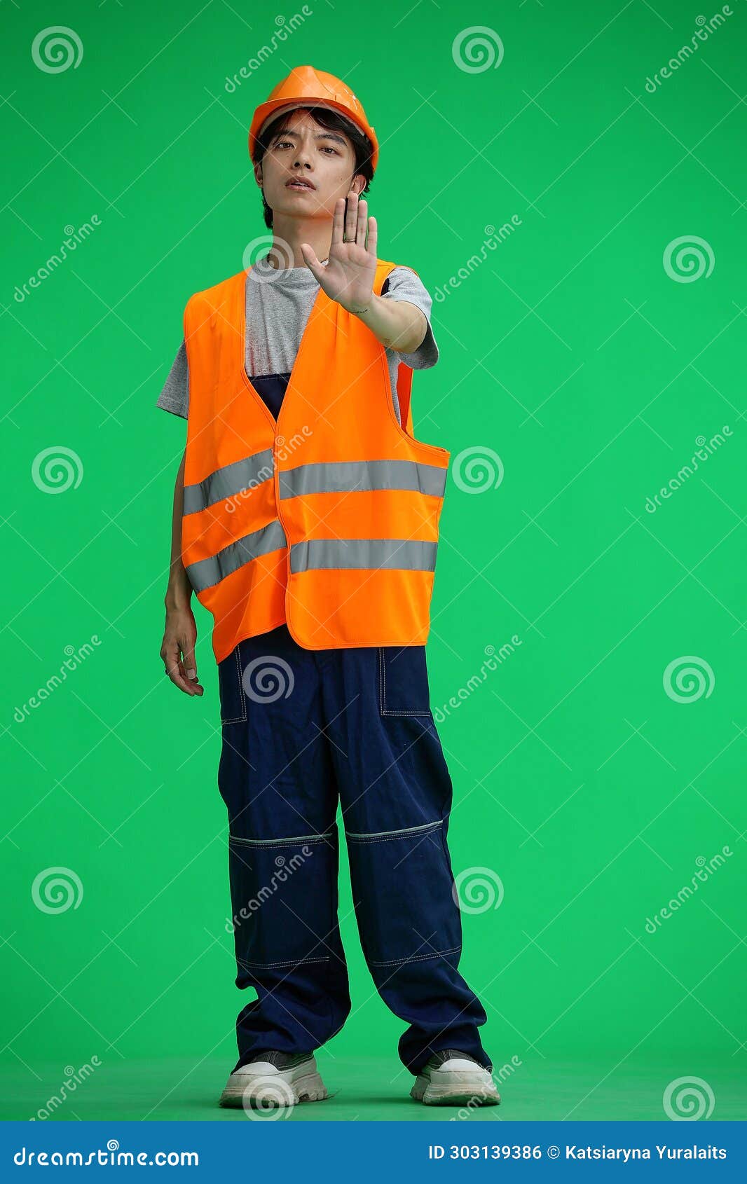 A Construction Worker Guy, on a Green Background, in Full Height, Shows ...