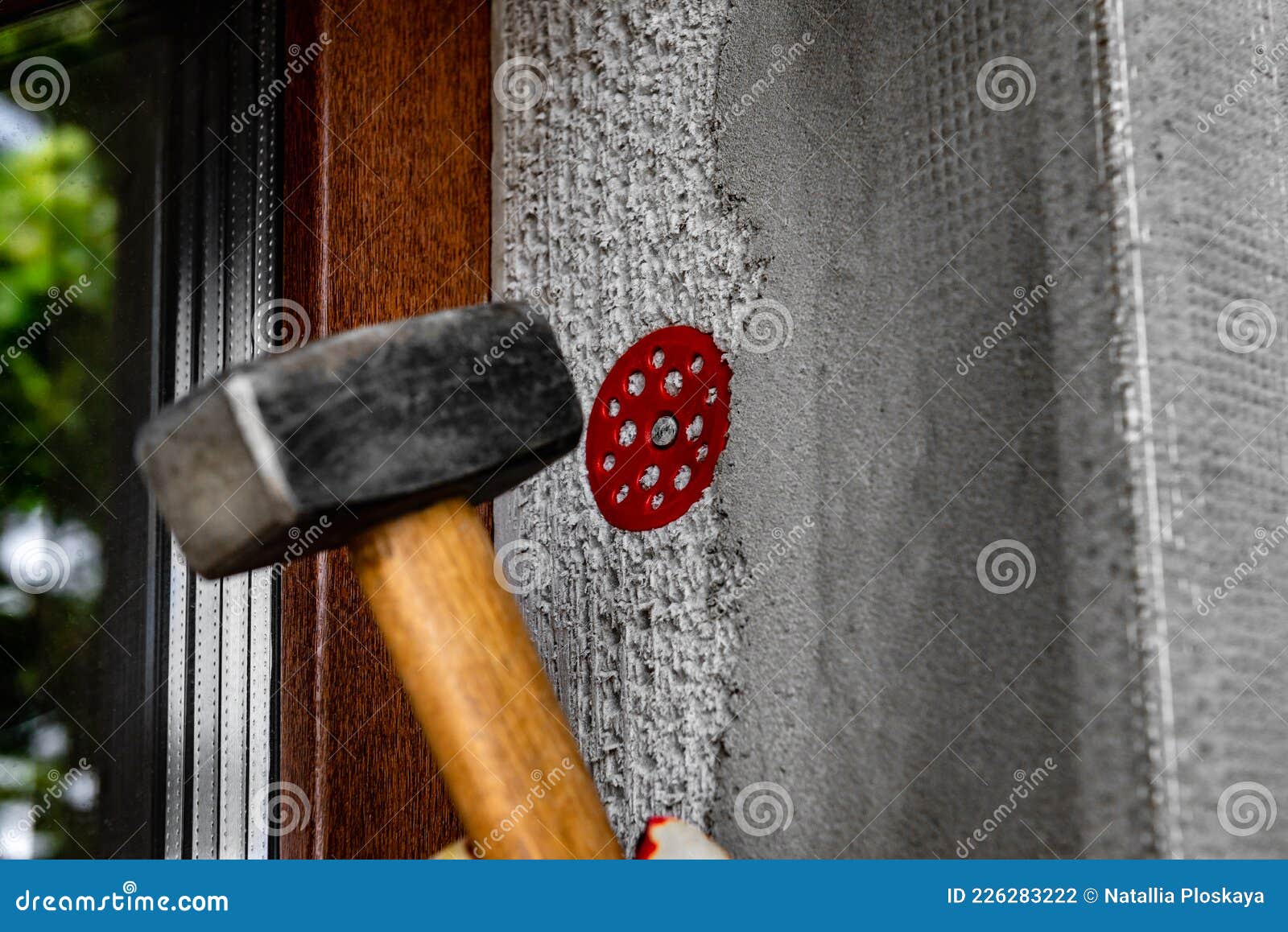 Construction Worker with Hammer Clogs Dowel into Plastic Umbrella ...