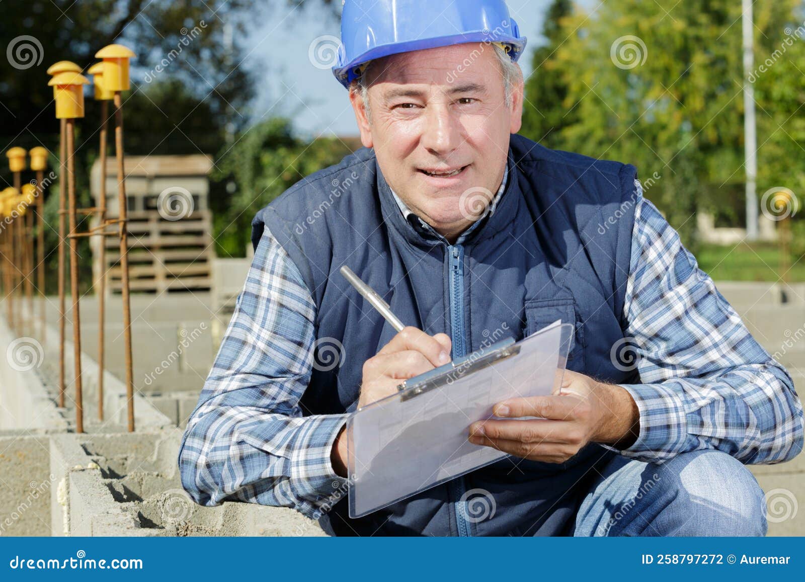 Construction Worker in Helmet Writing on Clipboard Stock Photo - Image ...