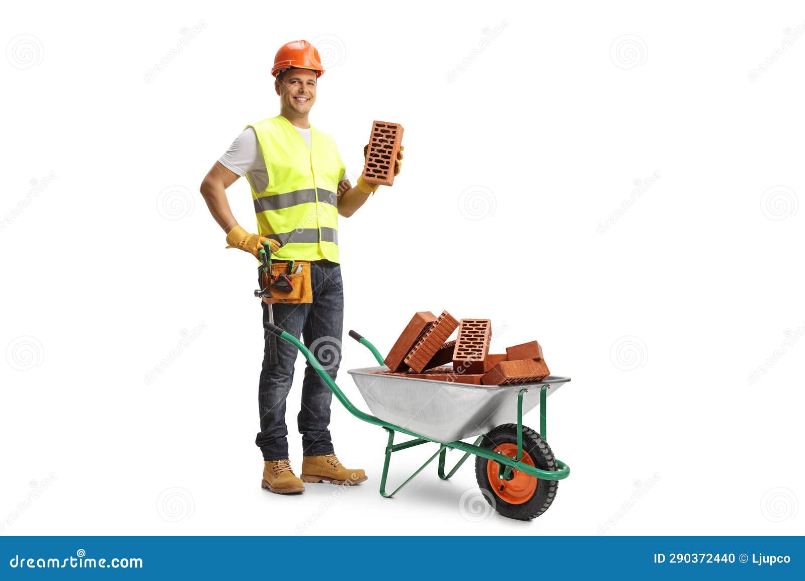 Construction Worker Holding a Brick and Standing Behind a Wheelbarrow ...