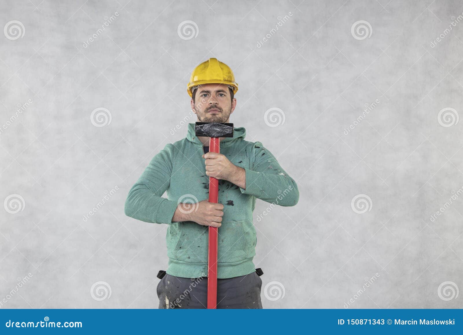 The Construction Worker is Holding a Hammer, Ready for Demolition Tasks ...