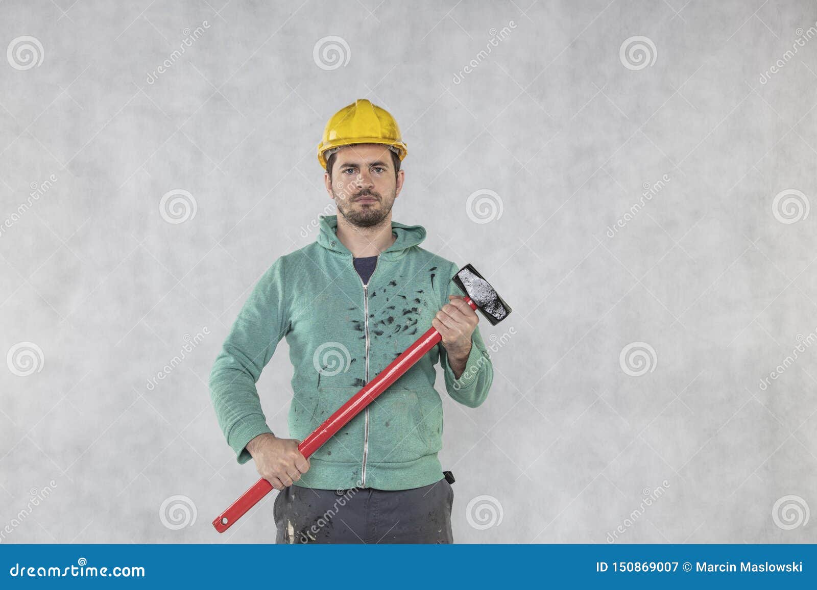 The Construction Worker is Holding a Hammer, Ready for Demolition Tasks ...